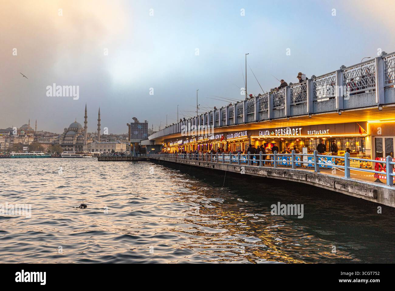 Istanbul, Turkey, 13 April 2025; People fishing on the Galata Bridge ...