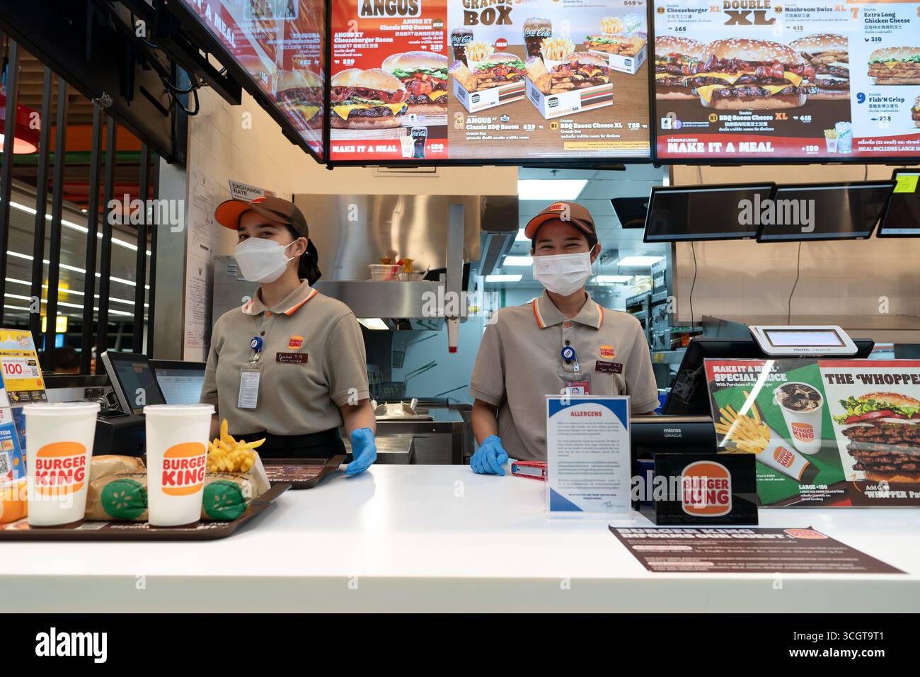 Bangkok, Thailand - October 17, 2024: two employees behind the counter ...