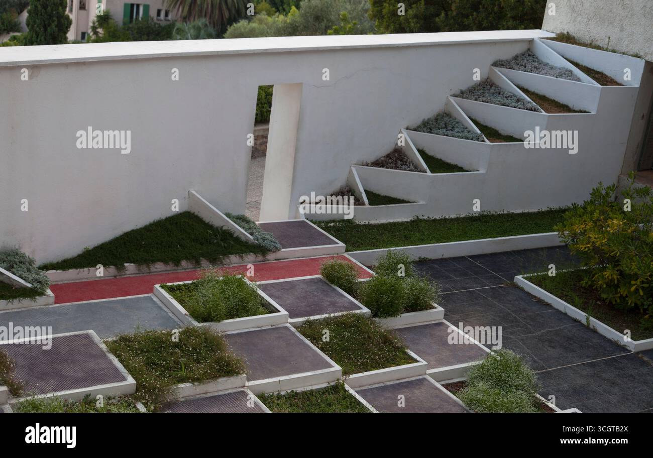 A series of divisions within a walled garden in France, including steps ...