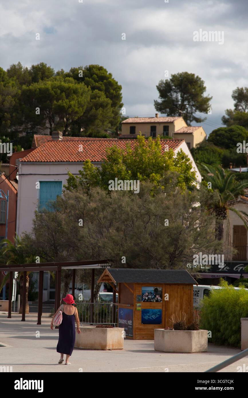 Woman walks past traditional mediterranean hi-res stock photography and ...