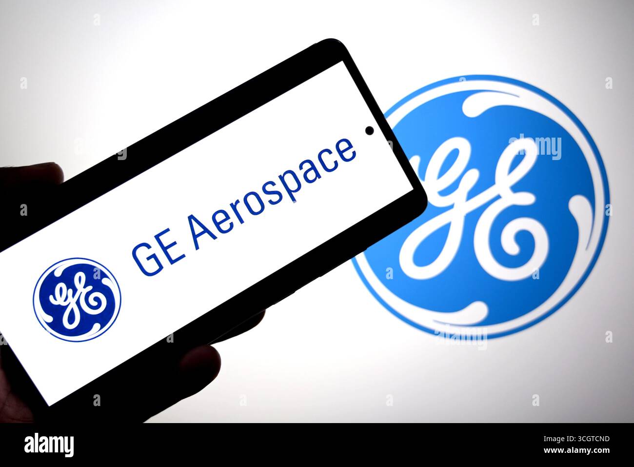 In this photo illustration, a GE Aerospace logo is seen displayed on a ...