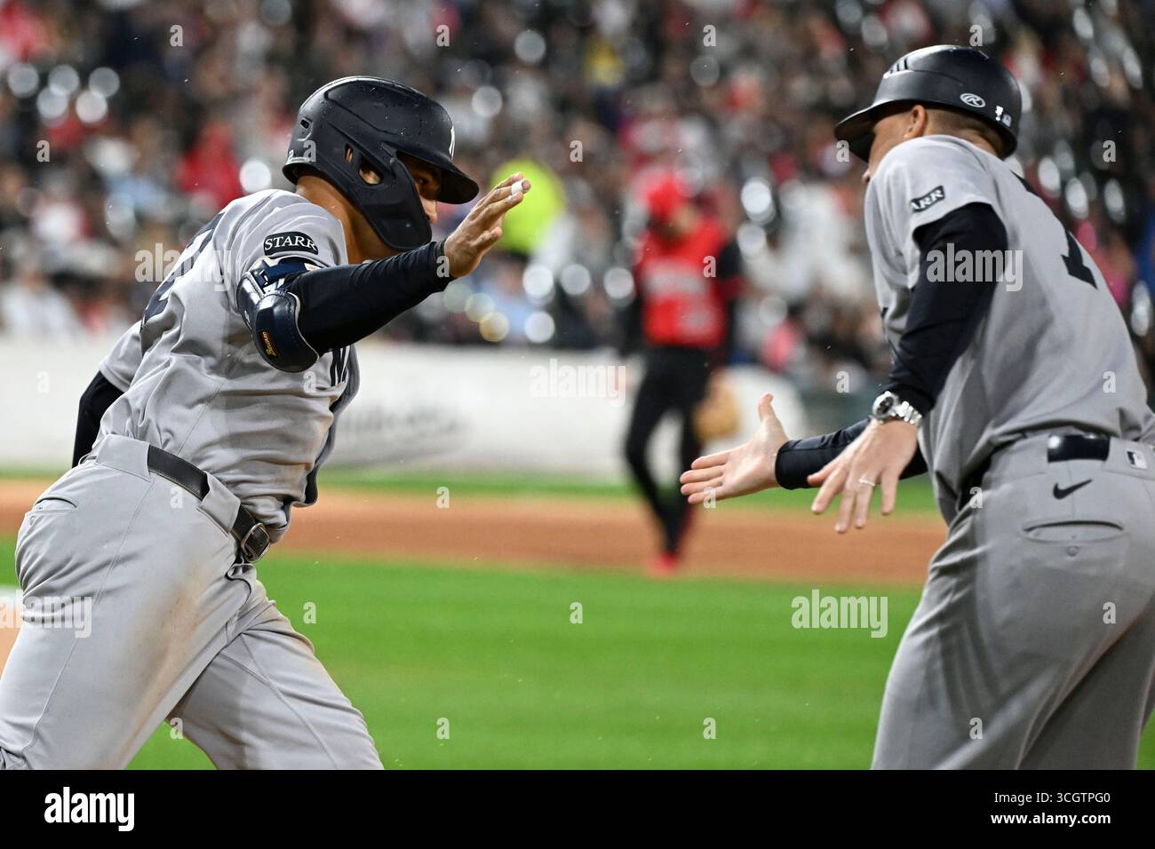 New York Yankees' Trent Grisham, left, high-fives first base coach ...