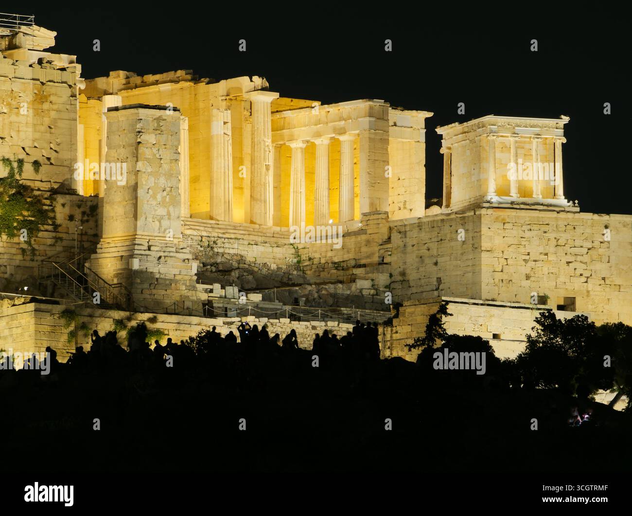 Ancient Greek Acropolis Propylaea in Athens lit up at night, showcasing ...