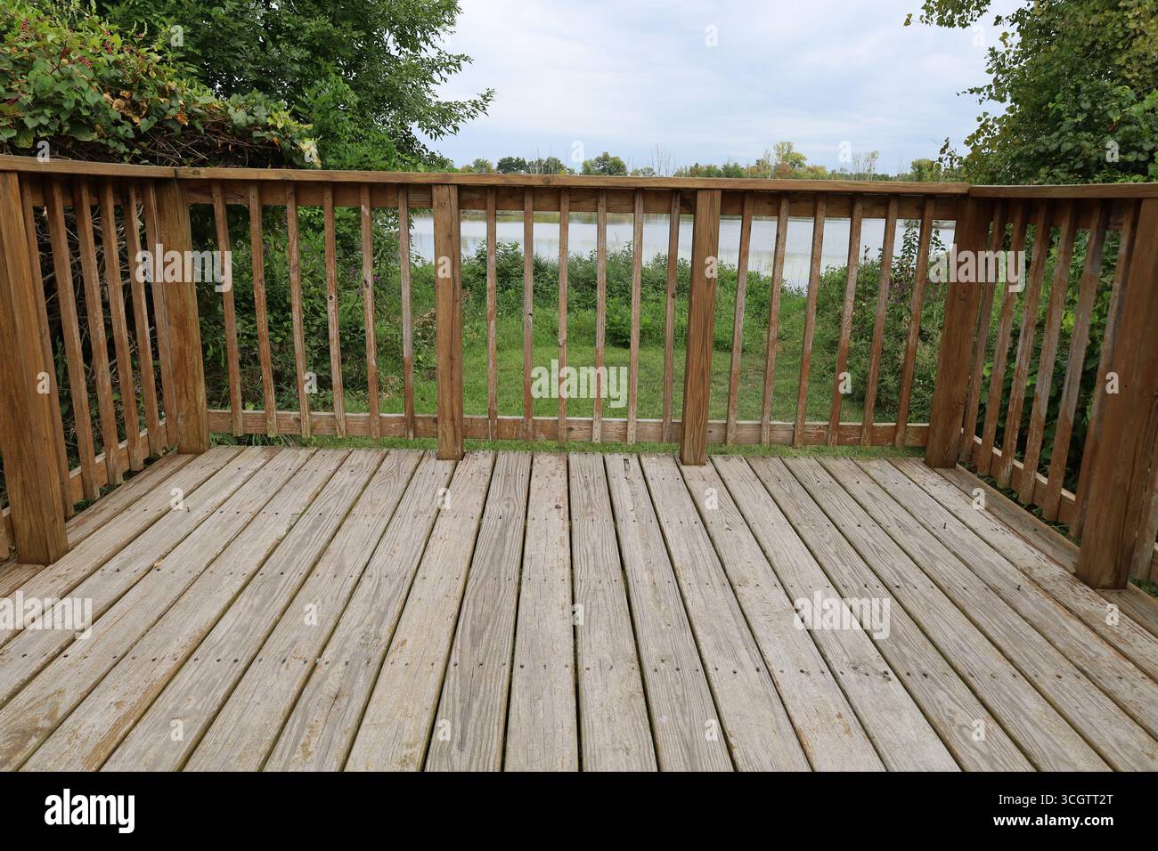 Wooden observation deck in nature preserve view towards wetlands lake ...