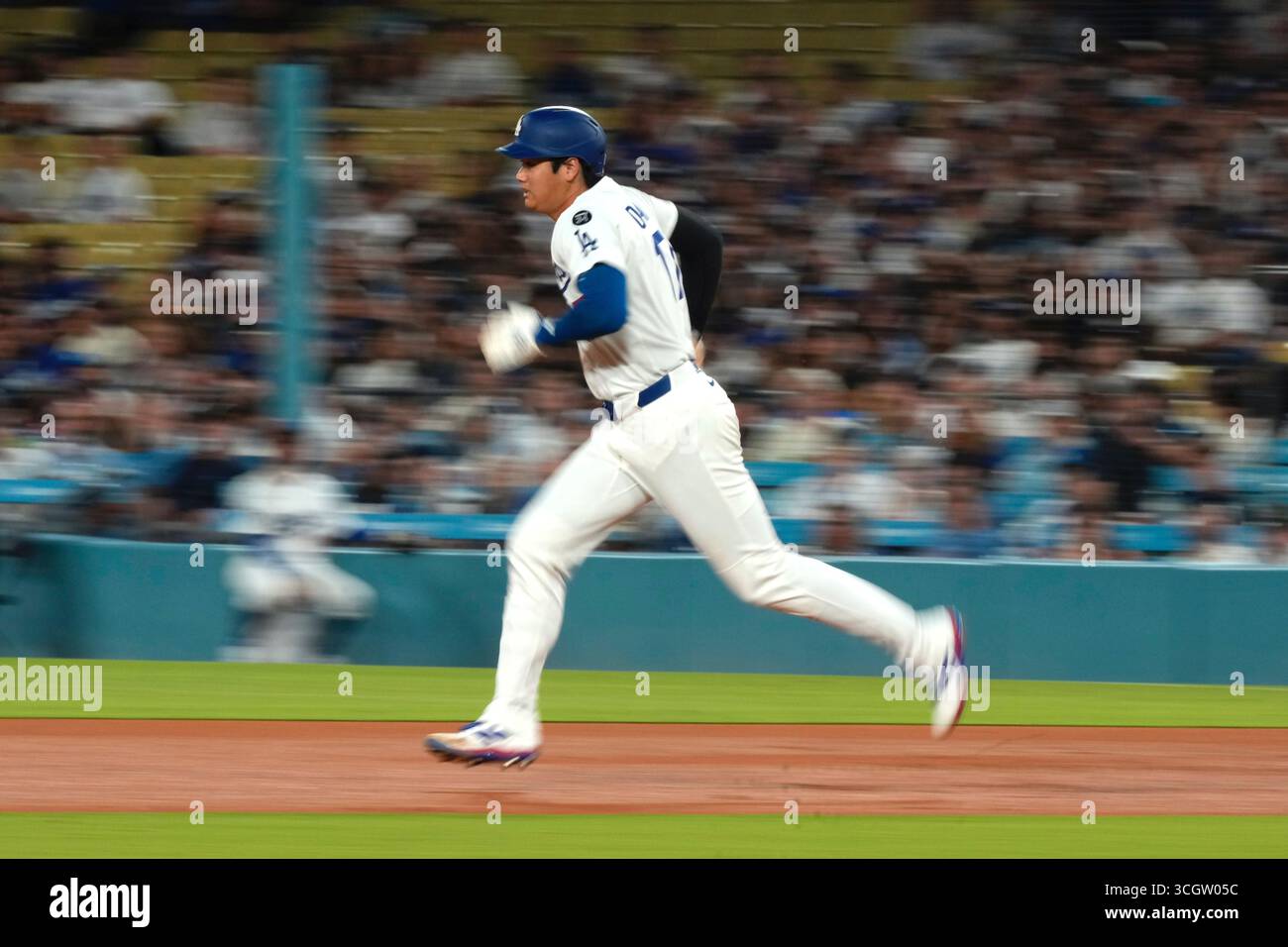 Los Angeles Dodgers' Shohei Ohtani runs to second as Mookie Betts pops ...