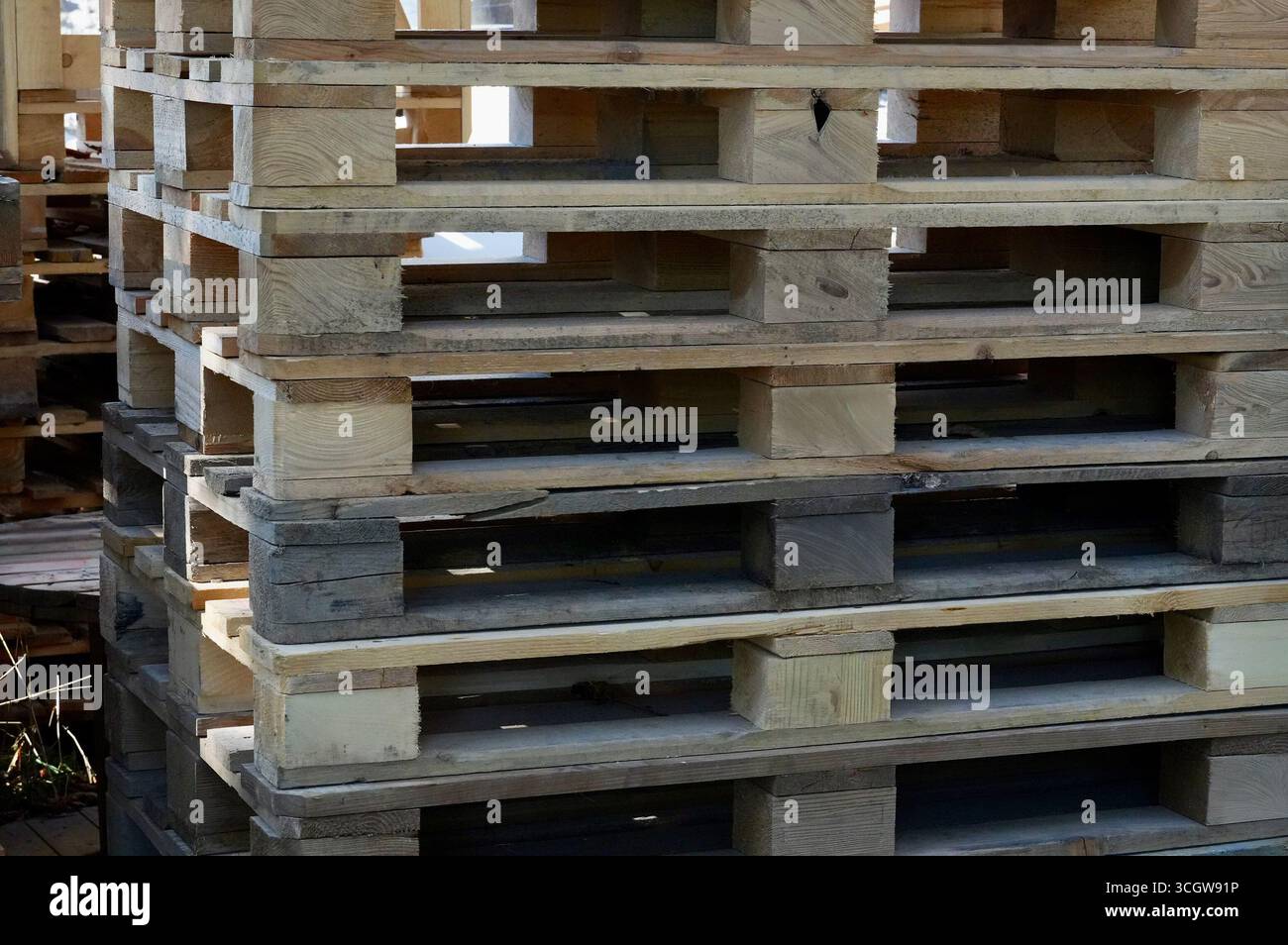 Wooden pallets stacked on top of each other in a warehouse Stock Photo ...