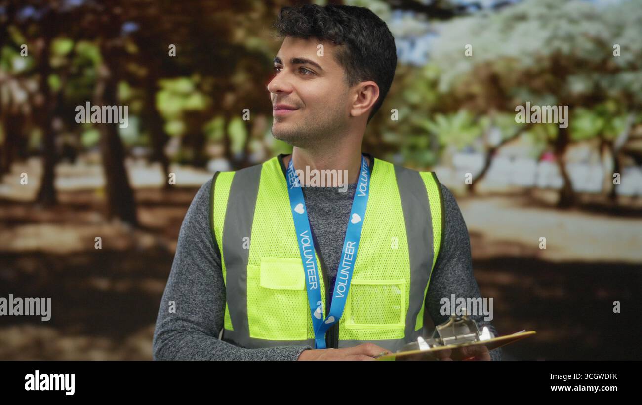 Man face smiling in park encourages hispanic young volunteer holding ...