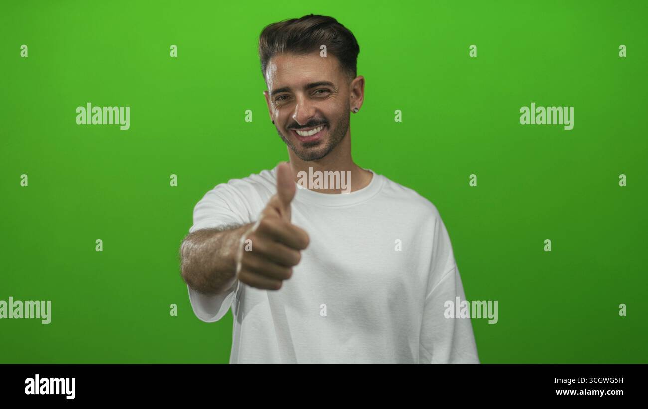 Man raises his arm with thumb extended in a thumbs up gesture against a ...