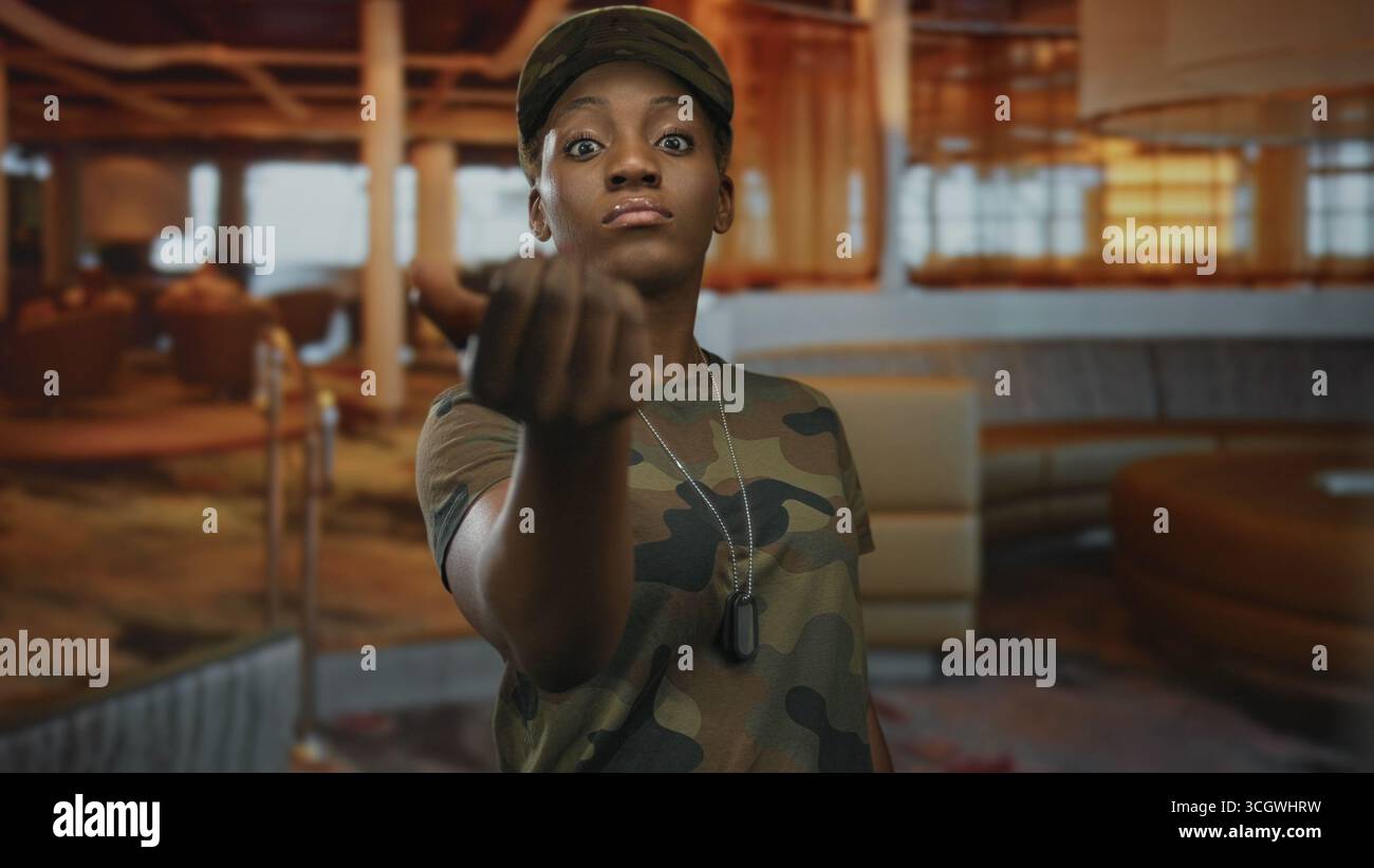 Soldier in camouflage uniform points index finger at camera inside ...