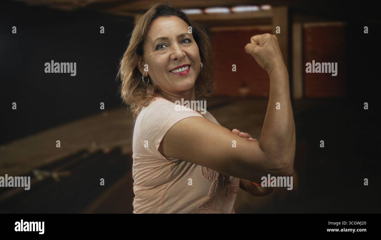 Woman flexes arm construction hi-res stock photography and images - Alamy