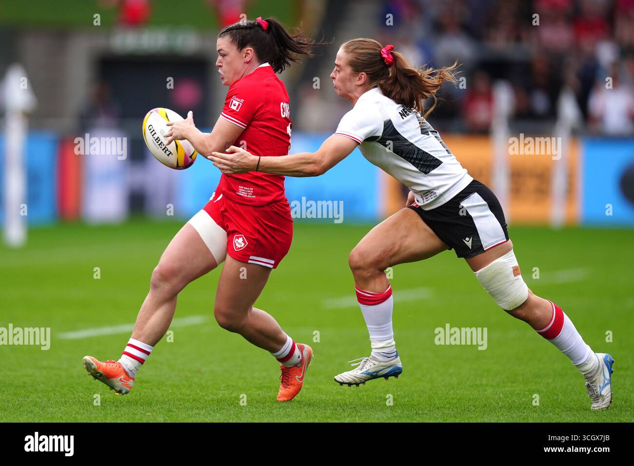 Canada's Alysha Corrigan (left) is tackled by Wales' Lisa Neumann ...