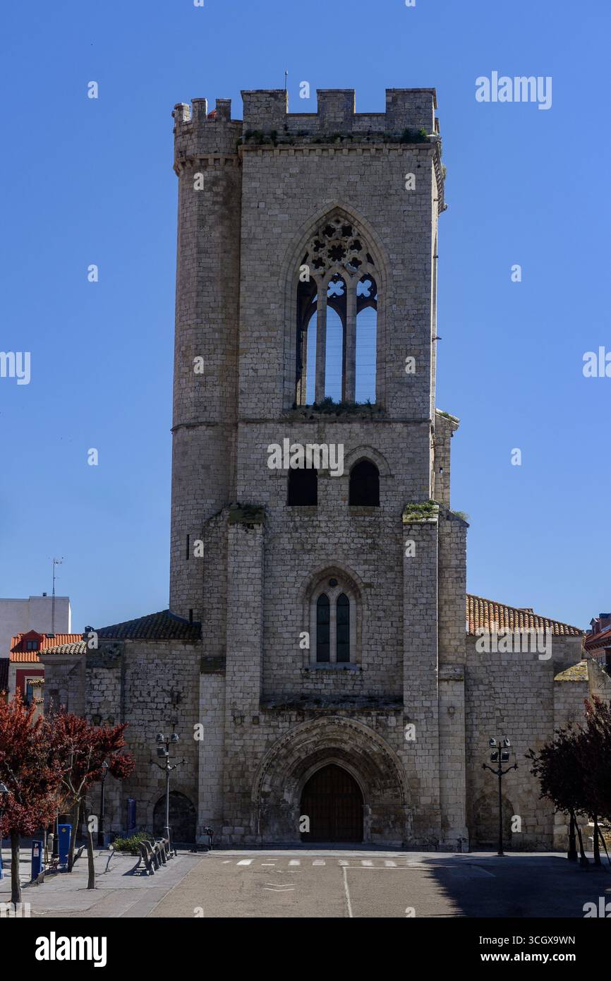 Medieval stone church with arched entrance and fortress-like bell tower ...