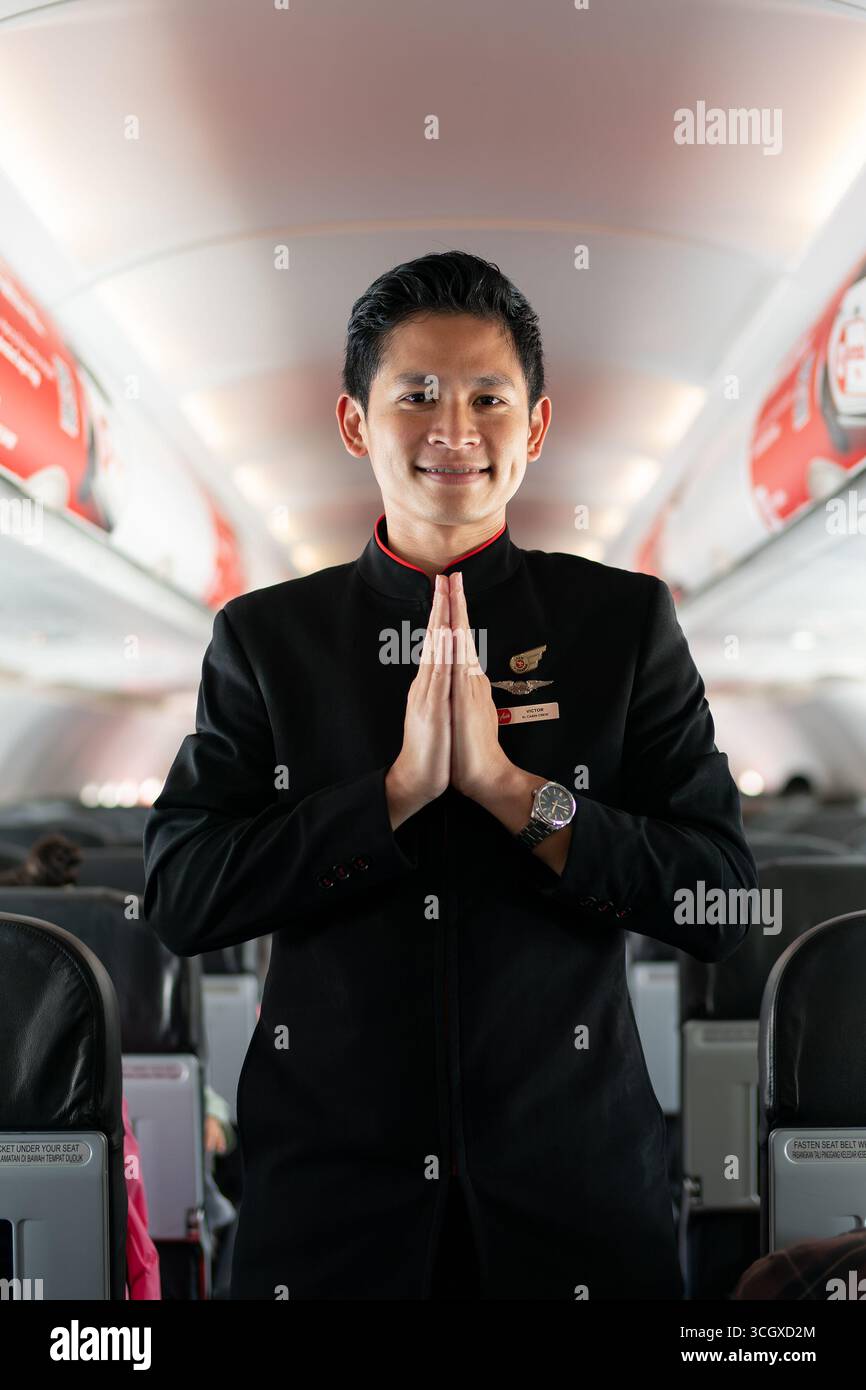 Kuala Lumpur, Malaysia - July 29, 2024: male AirAsia cabin crew member ...