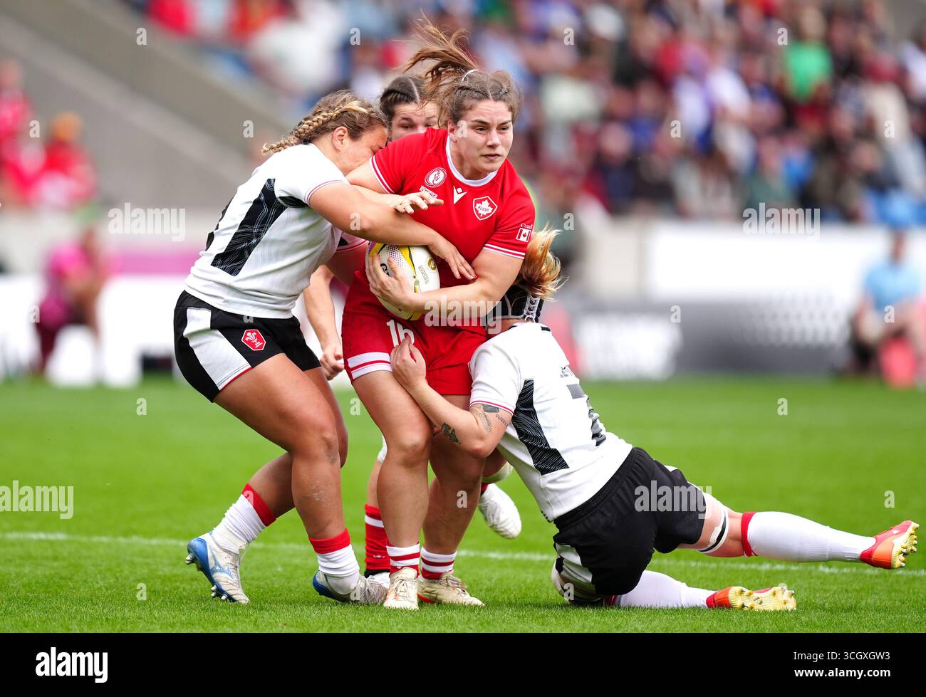 Canada's Gillian Boag (centre) is tackled by Wales' Jenni Scoble (left ...