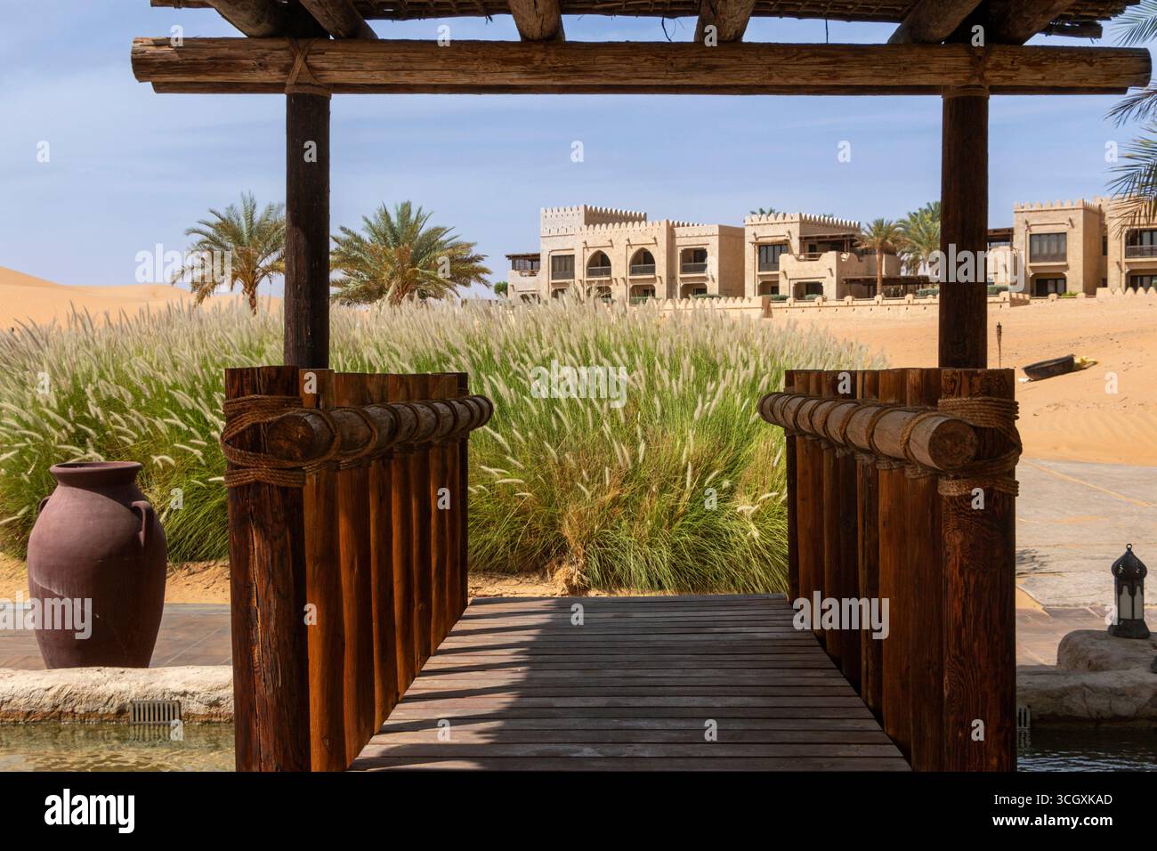 UAE - Liwa - Qasr Al Sarab - Wooden bridge leading to a desert oasis ...