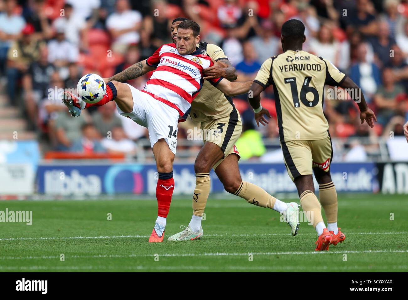Billy Sharp of Doncaster Rovers is challenged by Zak Jules of Rotherham ...