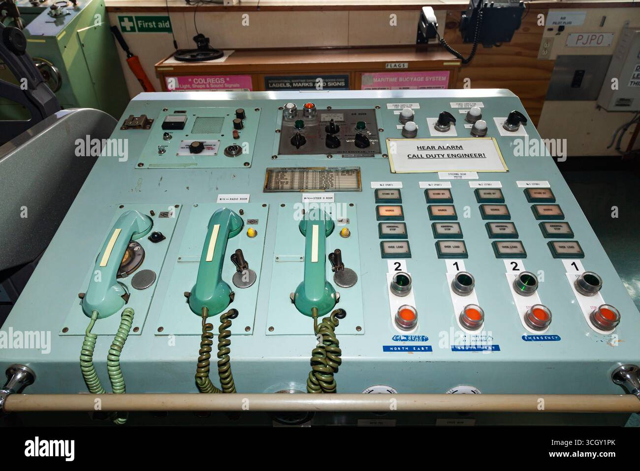 Boat control panel with analog corded telephones, buttons, switches and ...