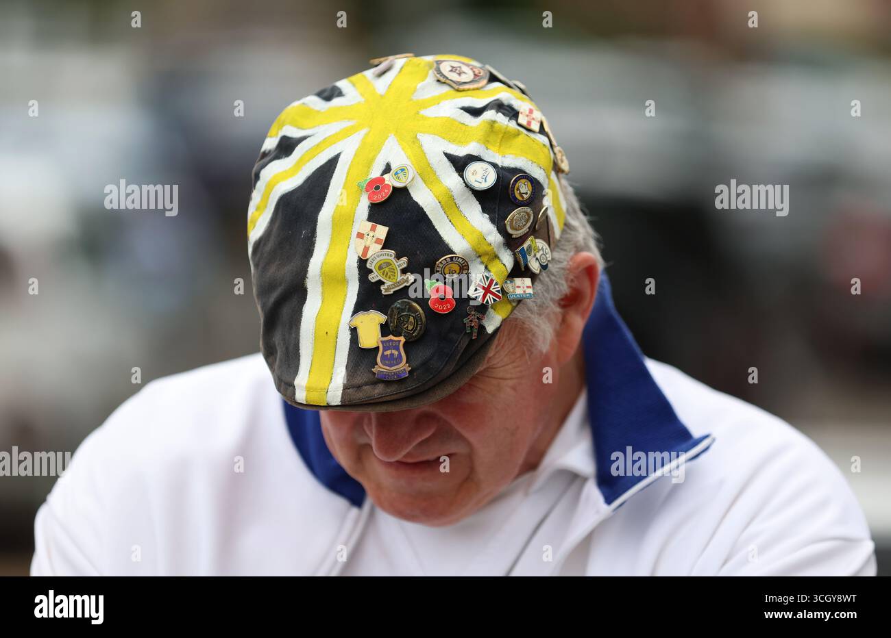 Pin badges on the hat of a Leeds United fan outside the ground before ...