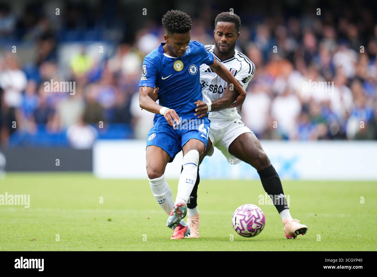 Estevao of Chelsea and Ryan Sessegnon of Fulham battle for the ball ...