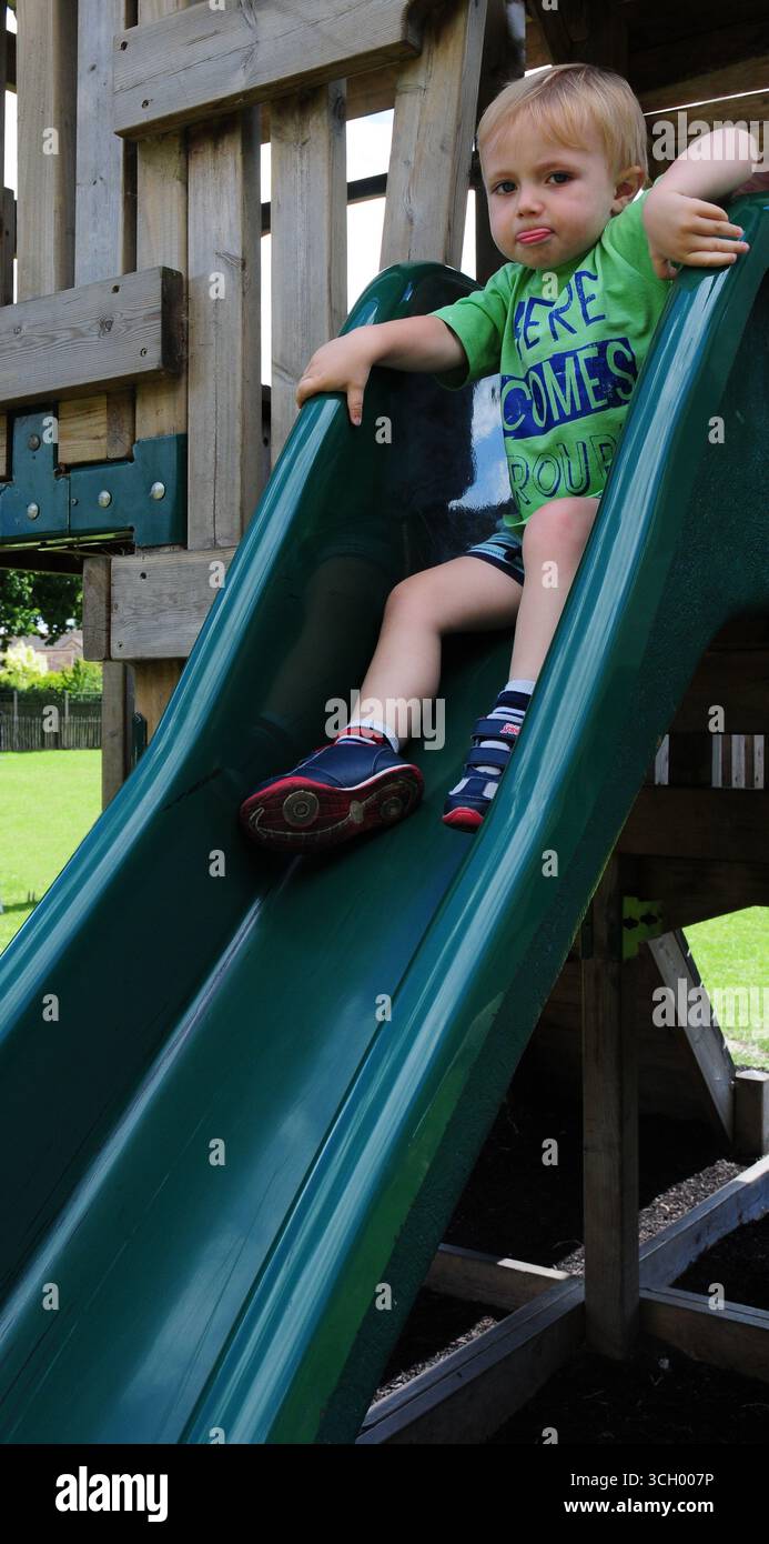 Kids playing on slide hi-res stock photography and images - Alamy