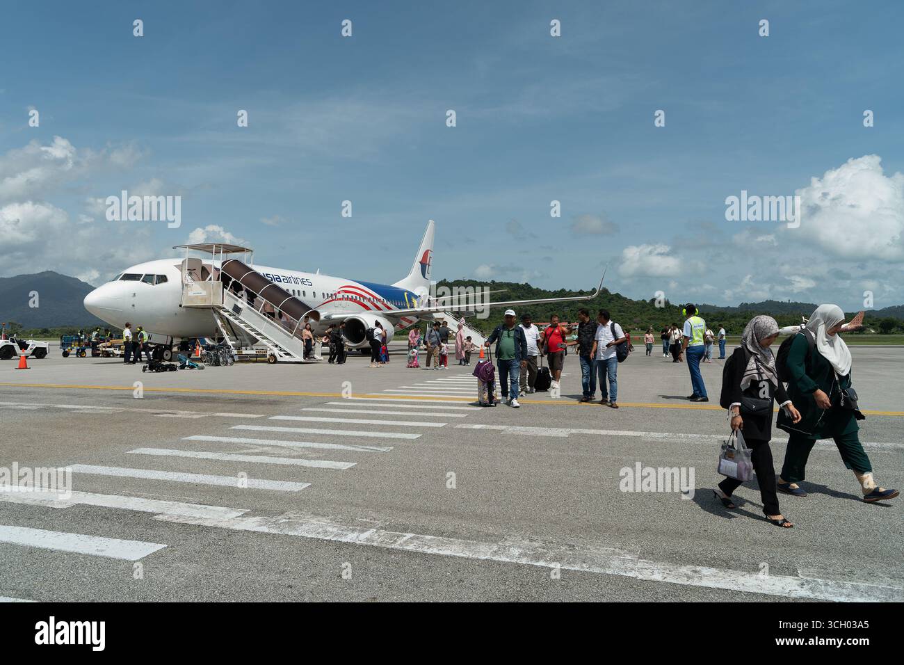 Langkawi, Malaysia - September 10, 2024: passengers walking across ...