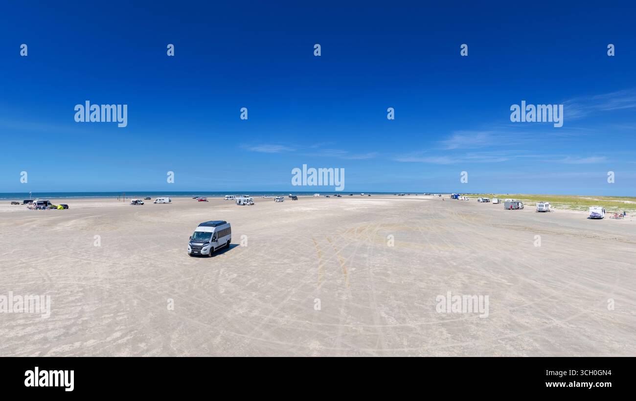 drone view of many mobile homes and RVs on the large sandy beach on ...