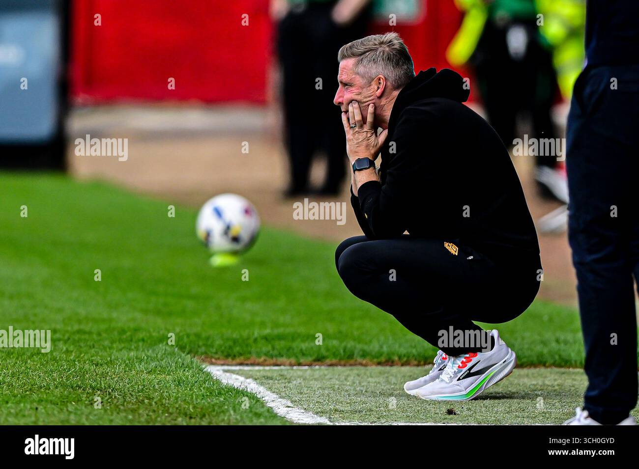 Manager Neil Harris (Manager Cambridge United) crouches down as he ...