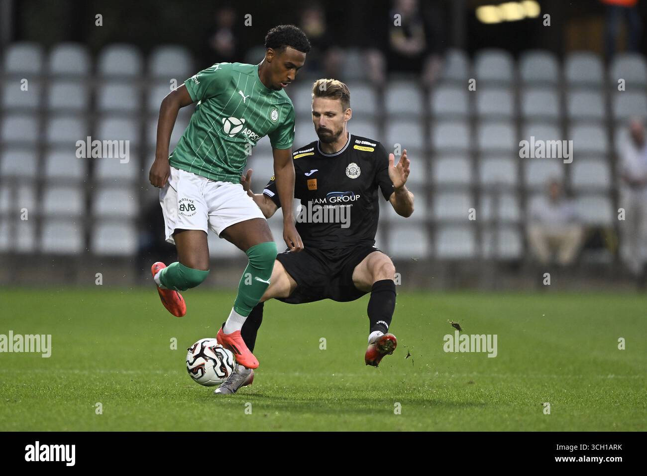 Lommel's Faniel Tewelde and Lokeren's Jonas Vinck fight for the ball ...
