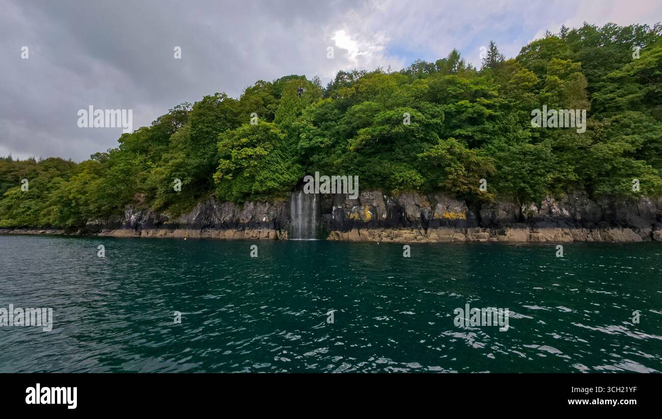 A waterfall flowing into the sea on the Isle of Mull, Argyll and Bute ...