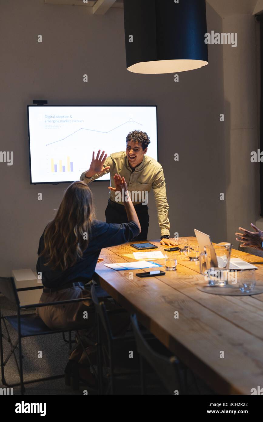 High fiving during successful hi-res stock photography and images - Alamy