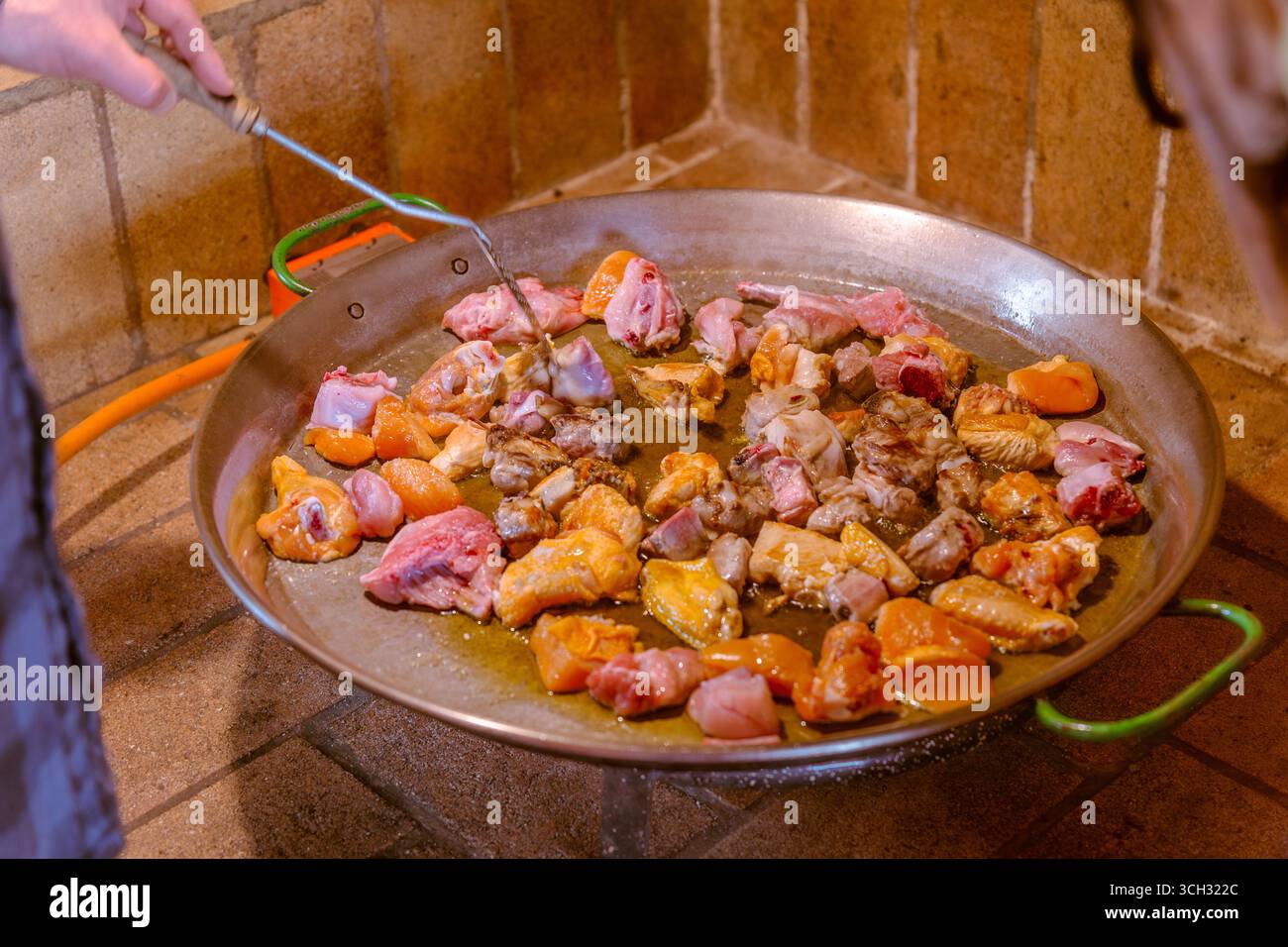 Person adding rice paella pan hi-res stock photography and images - Alamy