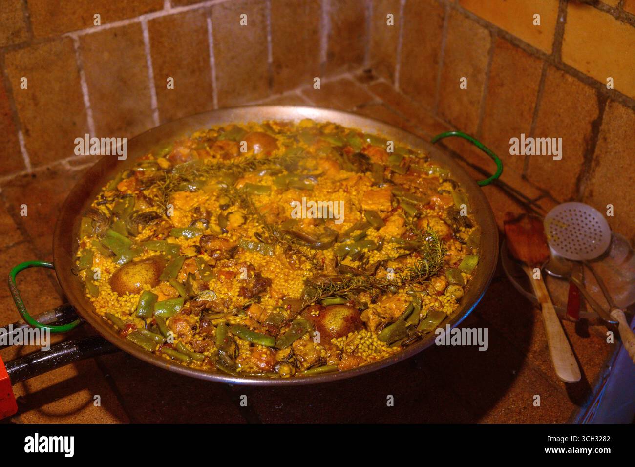 Traditional Valencian paella with meat and vegetables in a paella pan ...
