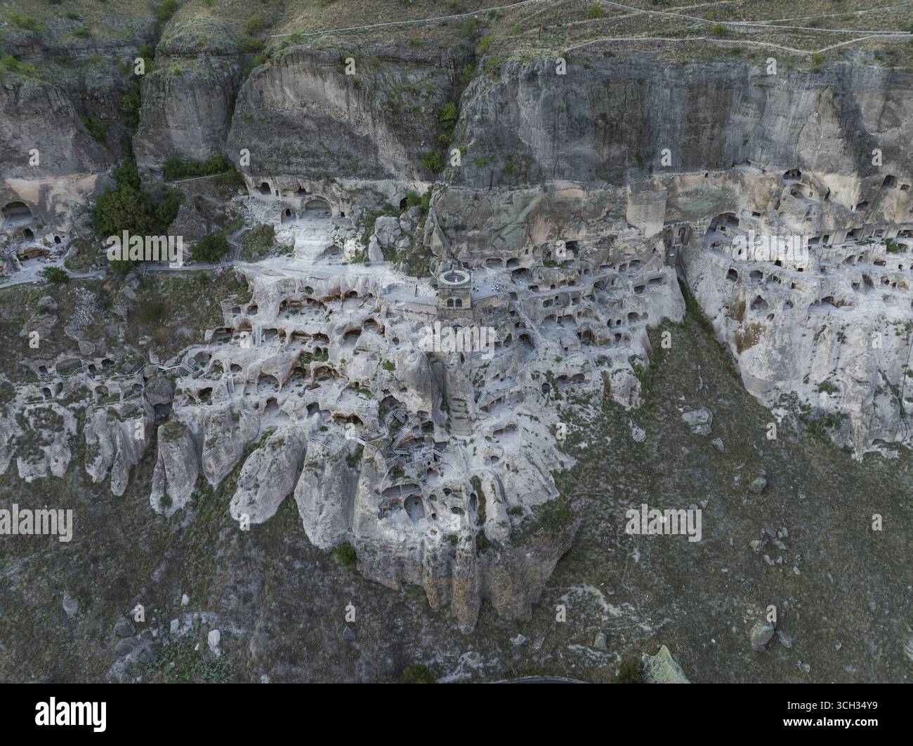 Aerial view of the ancient cave monastery complex, carved into the ...