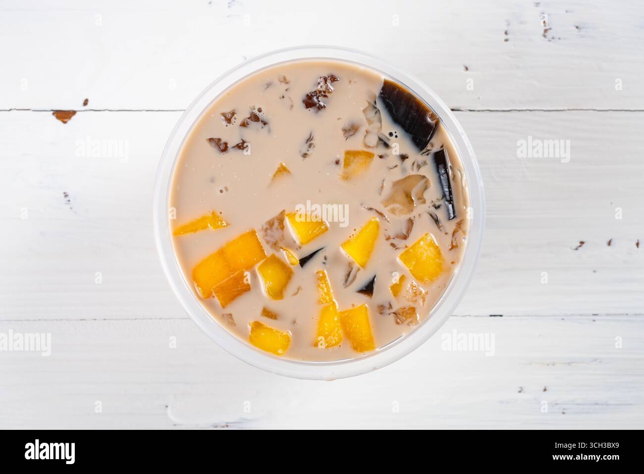 top view bowl of milktea flavor syrup mixed with grass jelly and ...