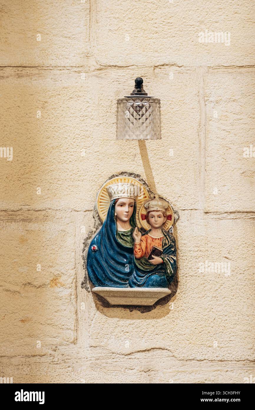 A small religious niche sculpture of the Virgin Mary and Child Jesus ...