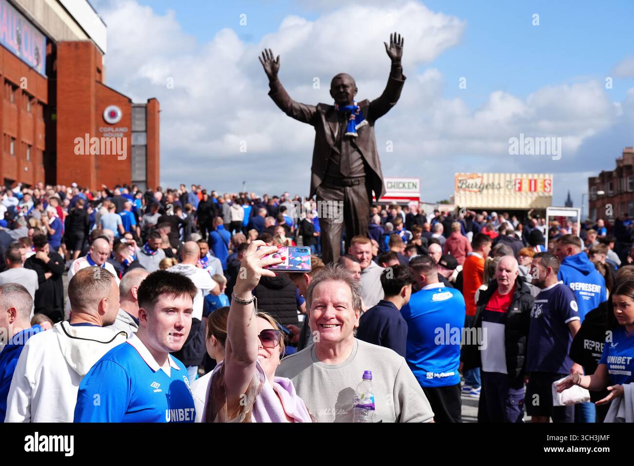 Rangers fans by a statue of former Rangers manager Walter Smith outside ...