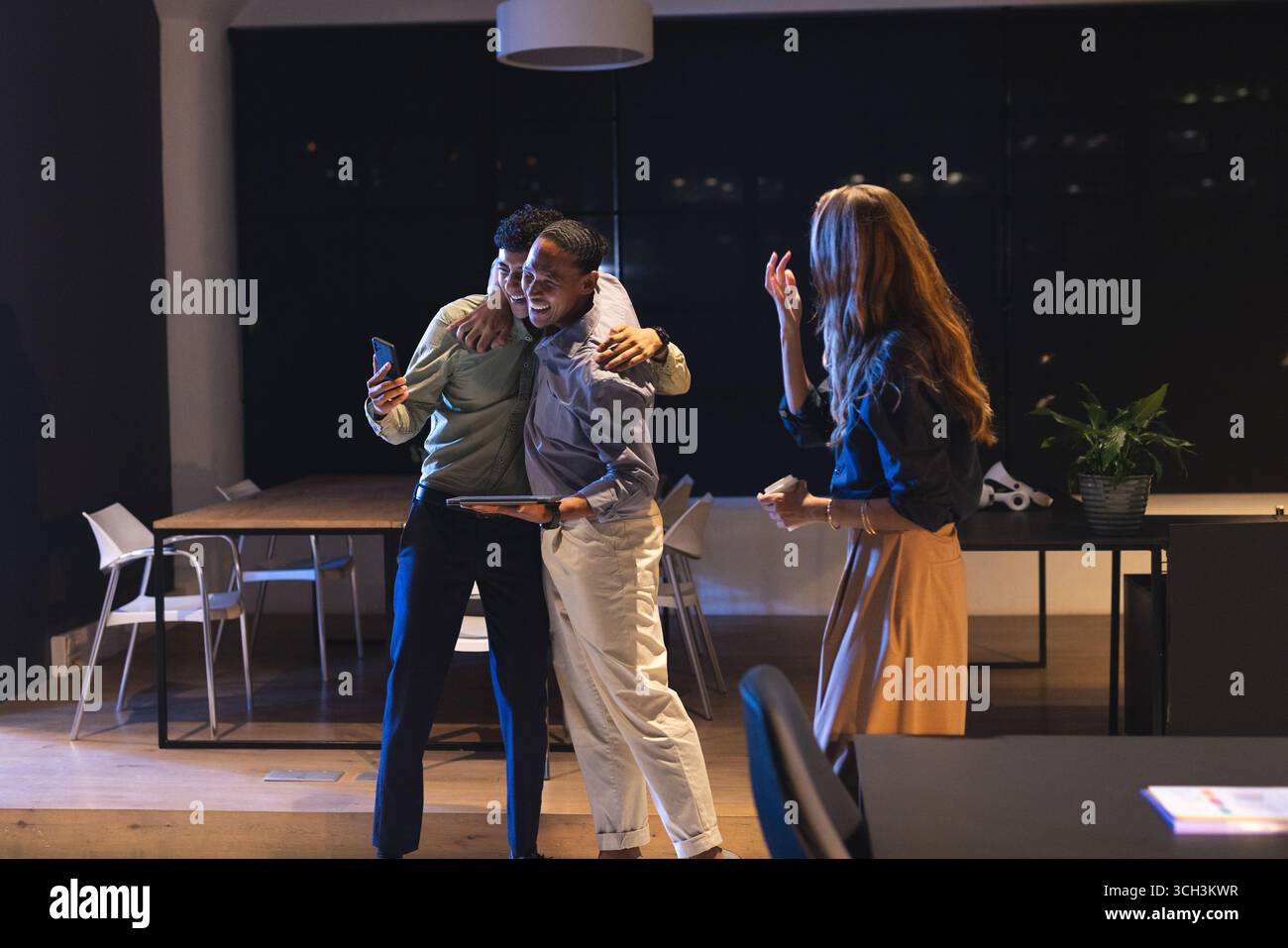 Colleagues hugging smiling celebrating hi-res stock photography and ...