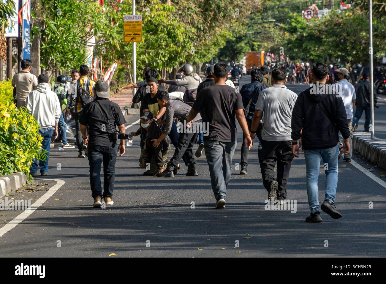 A group of plainclothes police officers detain a demonstrator during a ...