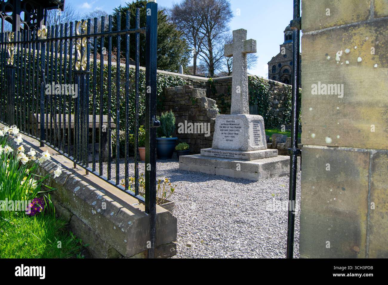 Cliviger war memorial with a stone cross stands on a gravel plot ...
