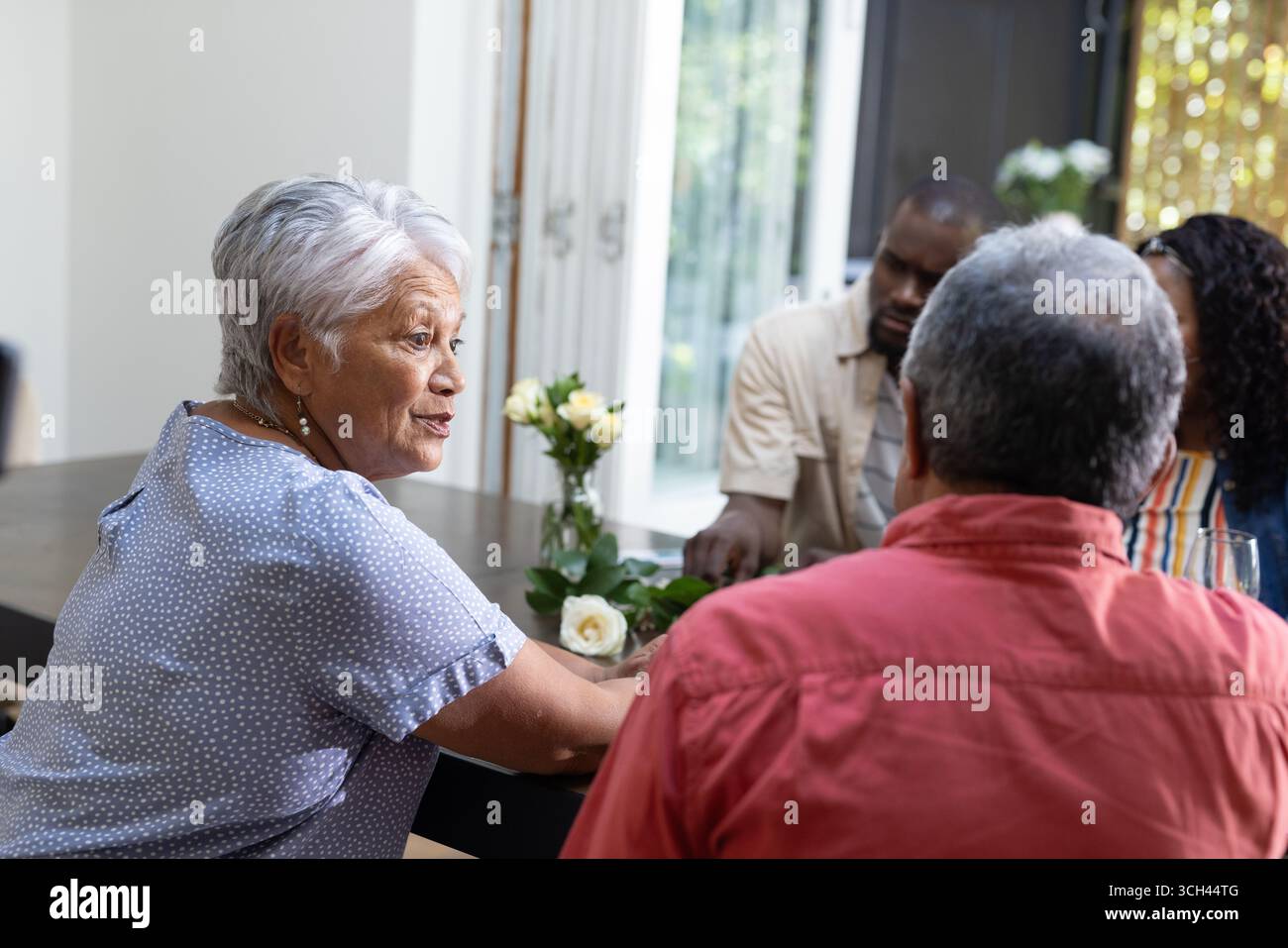 Diverse family gathering dining hi-res stock photography and images - Alamy
