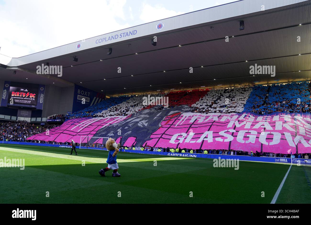 Rangers fans display a tifo and hold up coloured cards at half time ...