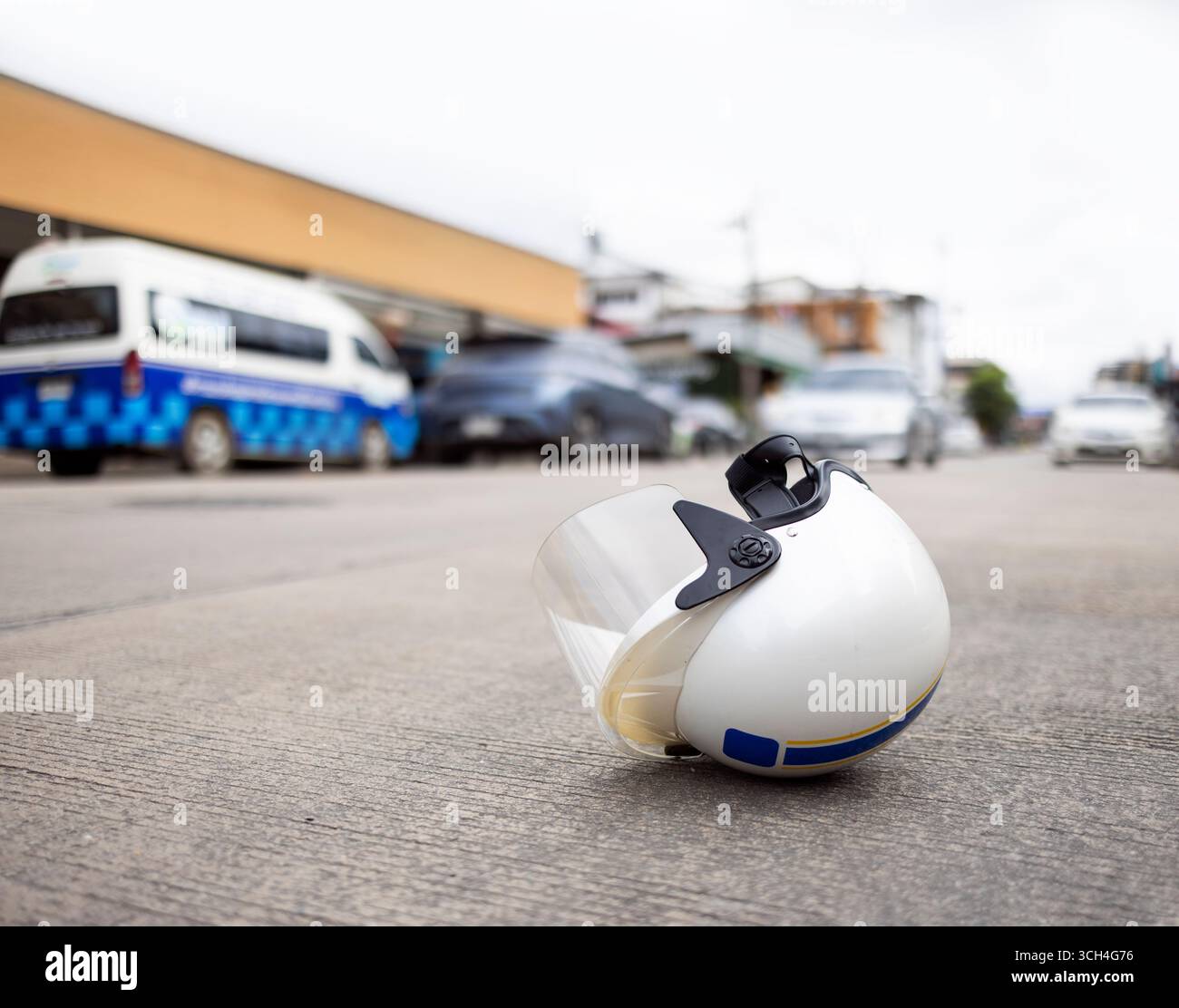 Protective motorcycle helmet lying on urban street symbolizing traffic ...