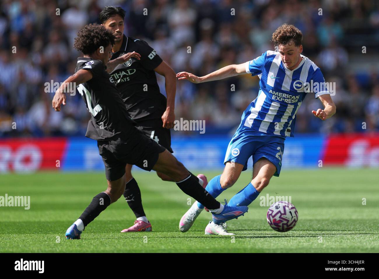 Manchester City's Oscar Bobb, left, challenges for the ball with ...