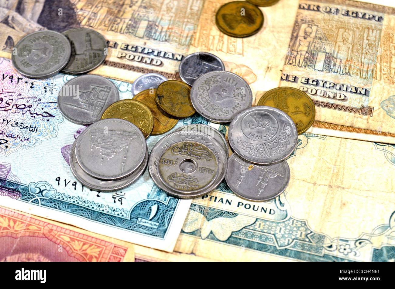 Egyptian old coins and a stack of old Egyptian money banknotes of ...
