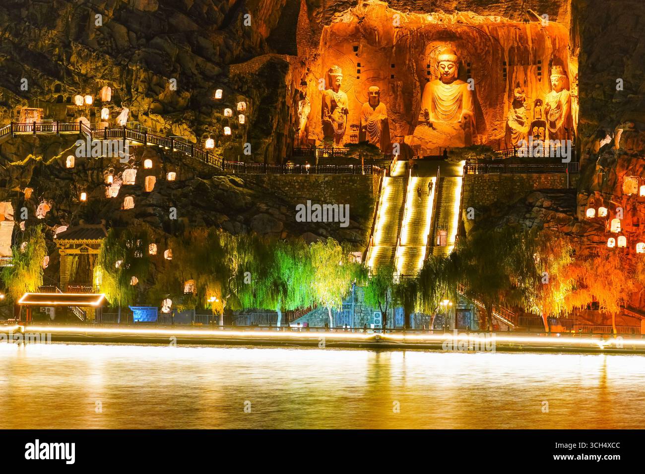 View of the historic Longmen Grottoes along the Yi River at night in ...