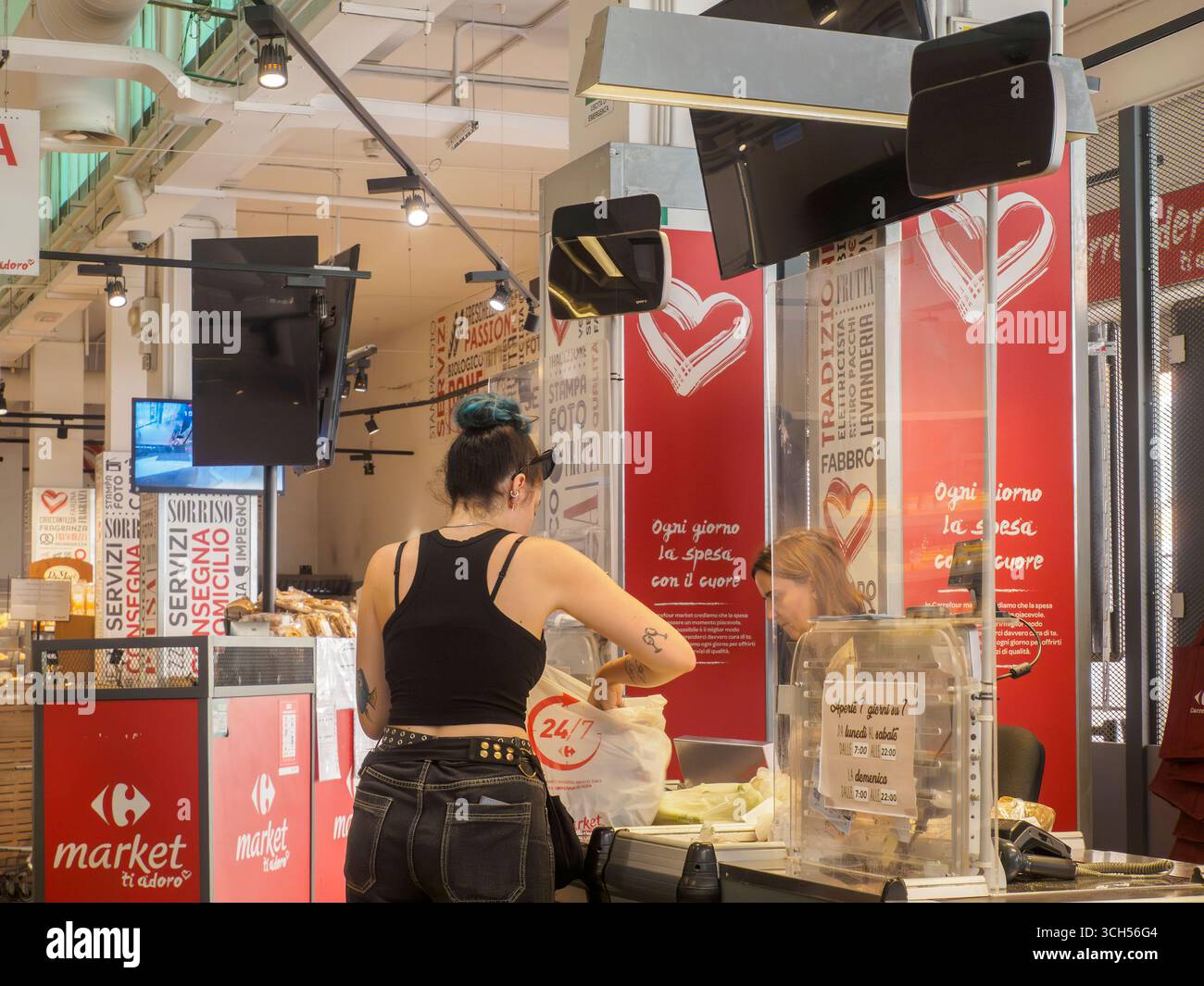 Cremona, Italy - August 14th 2025 Customers purchasing groceries at a ...