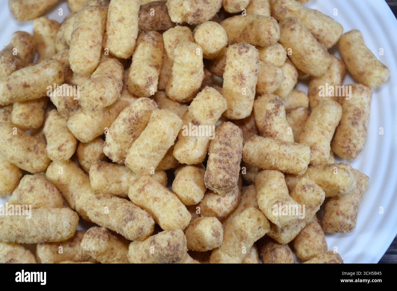 sweet peanut flavored puffs, Puffcorn or corn puffs are puffed or ...