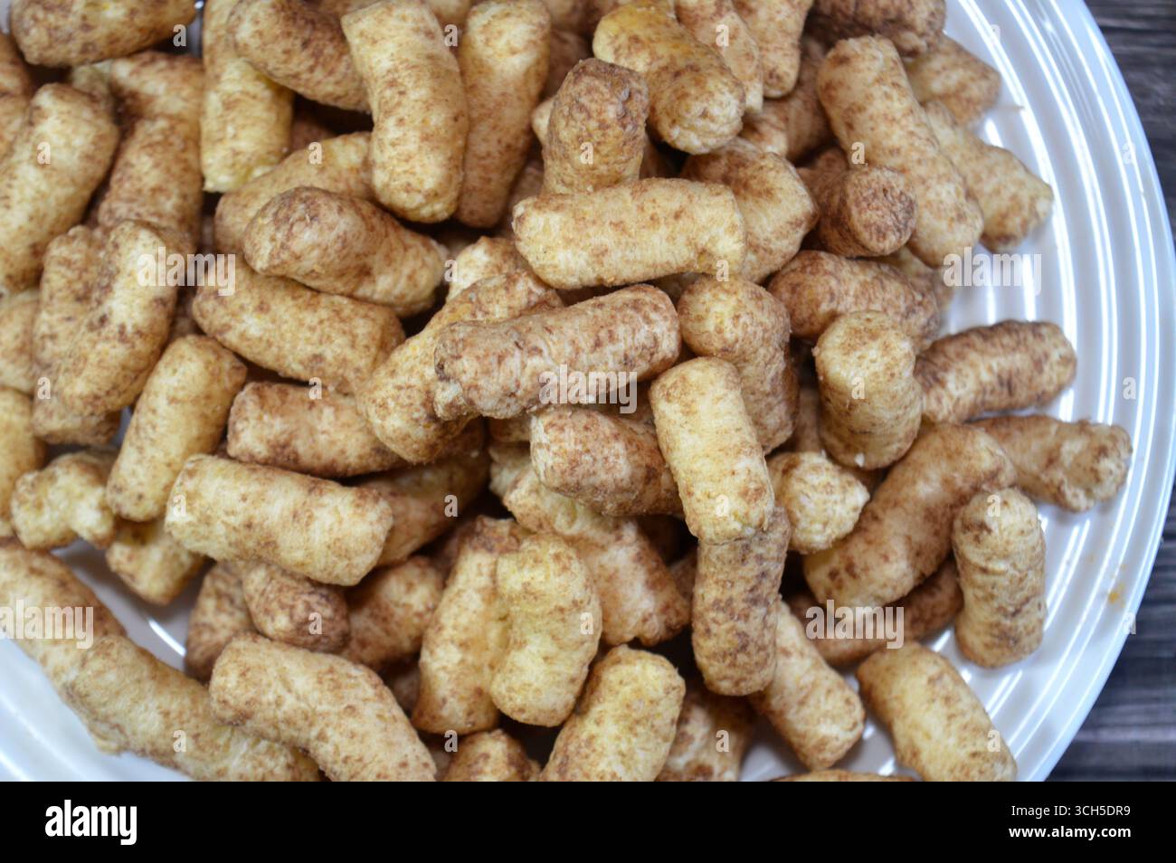 Peanut Puffcorn or corn puffs are puffed or extruded corn snacks made ...
