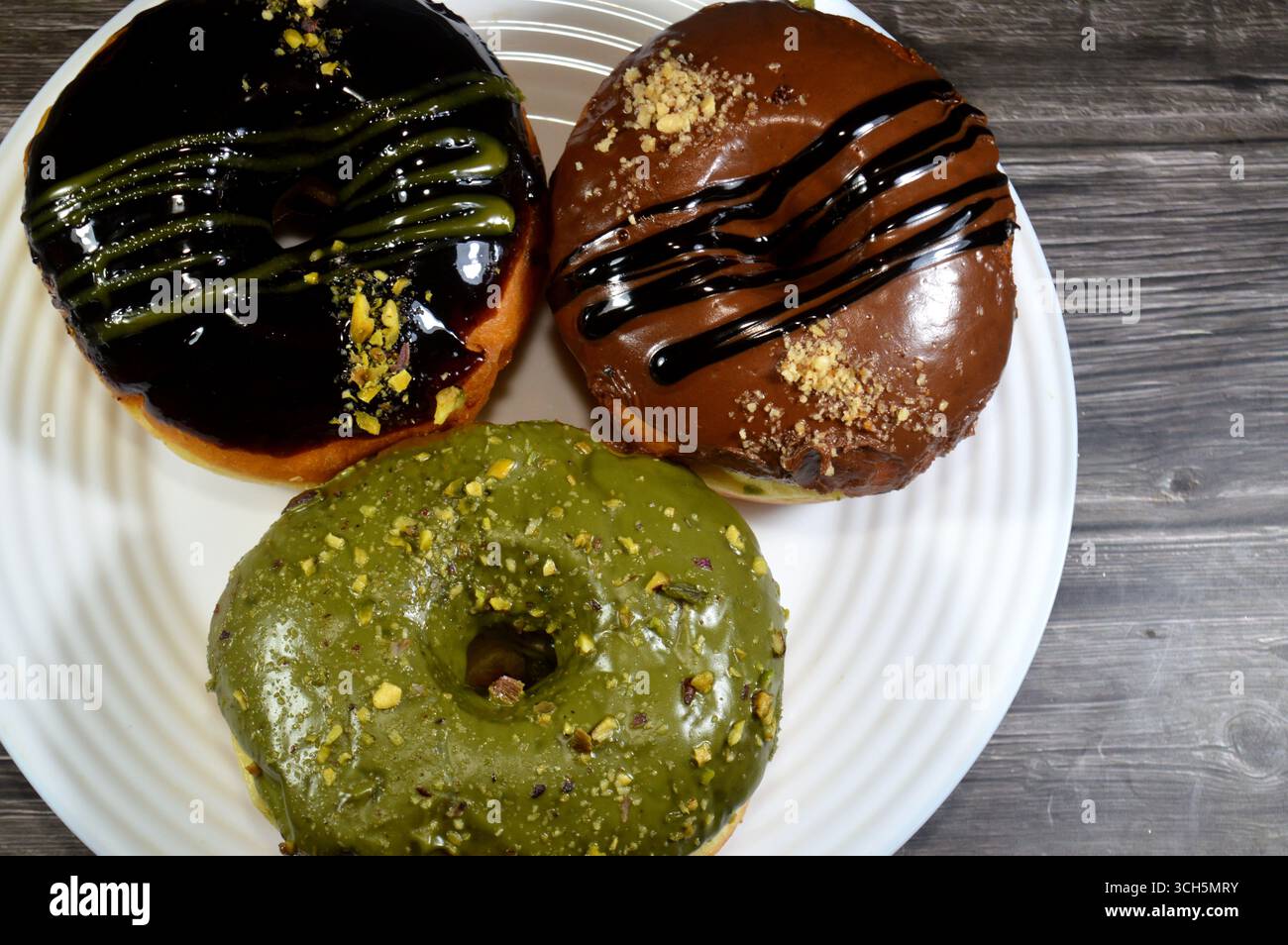 assorted toppings of pistachio, dark and brown chocolates, hazelnut ...