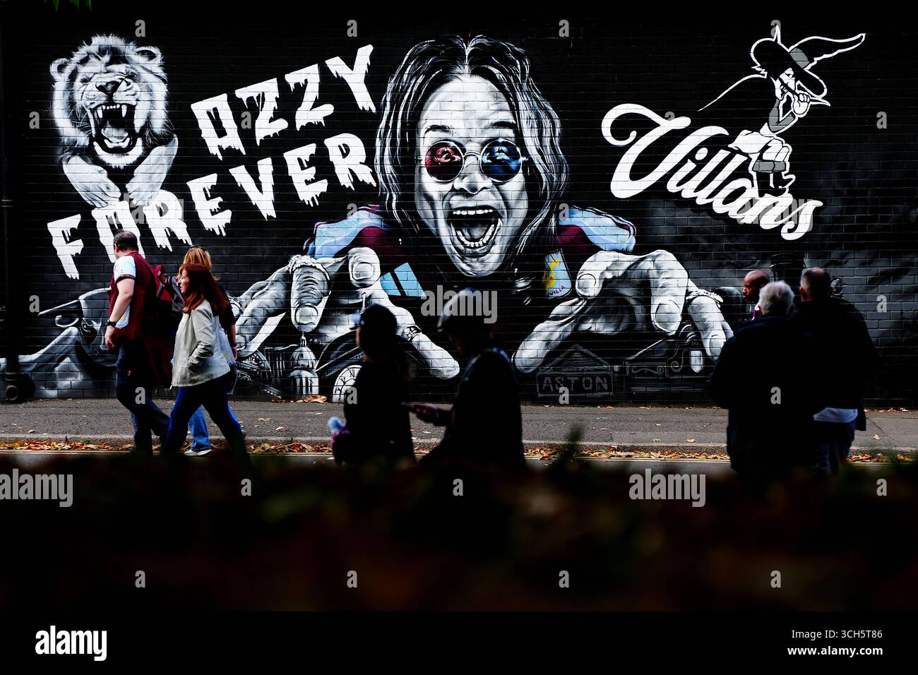 Aston Villa fans walk past a mural dedicated to Ozzy Osbourne near the ...